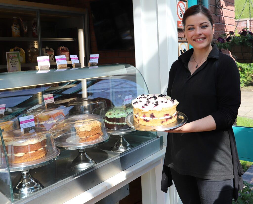 Abigail with cake - Walled Garden Cafe - Derwen College